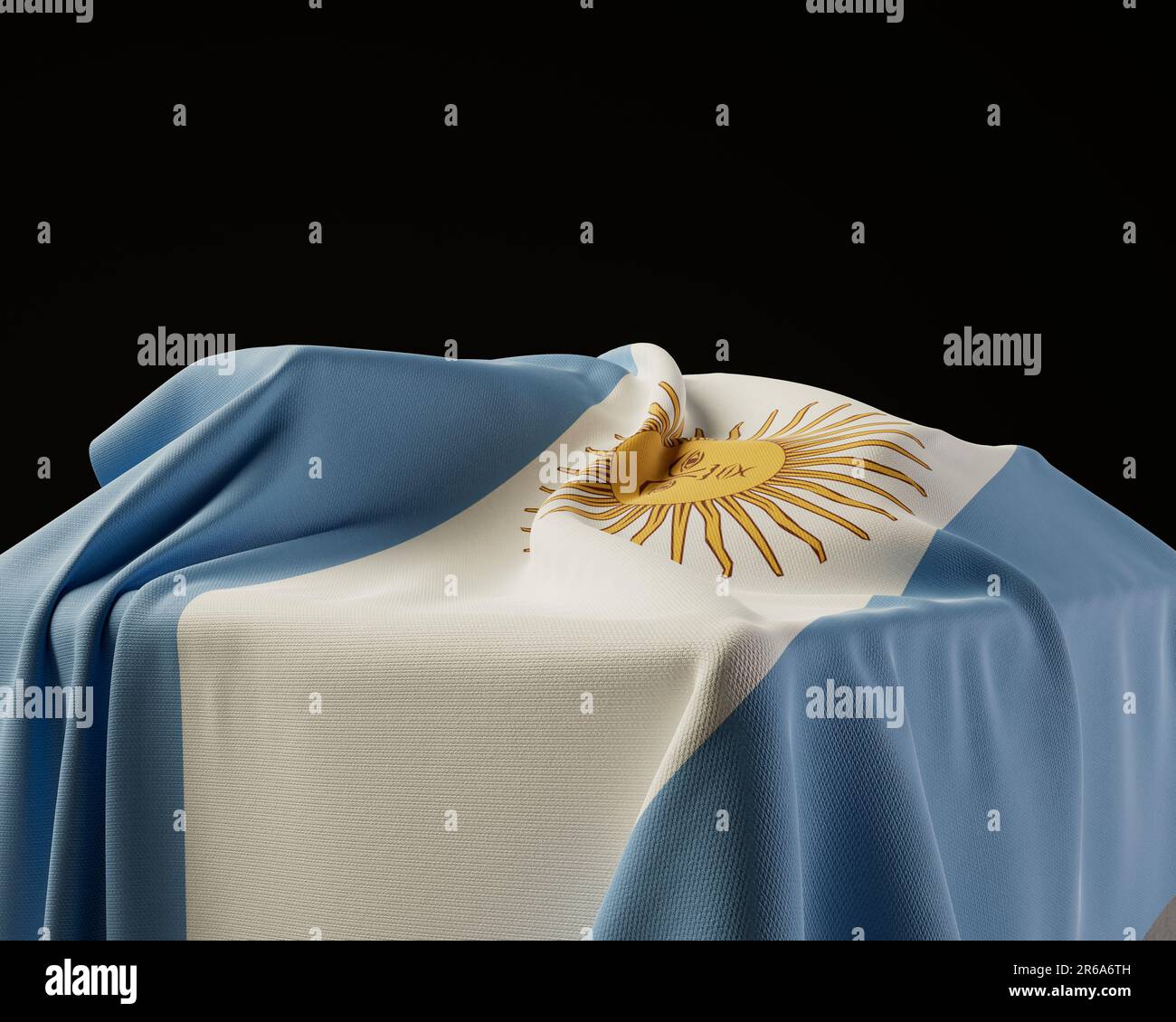 A argentina flag draped over a stone plinth on an isolated dark studio ...