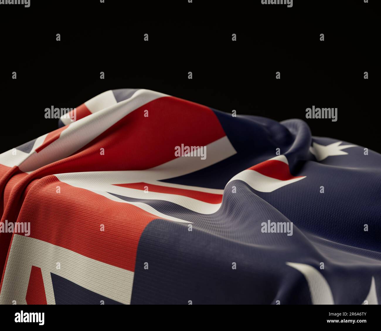A australia flag draped over a stone plinth on an isolated dark studio ...