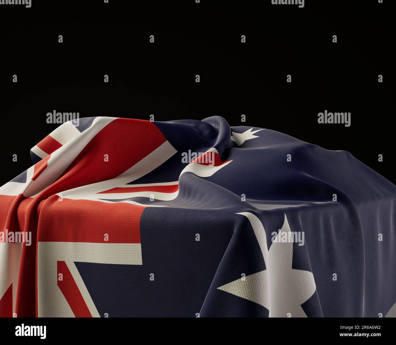 A australia flag draped over a stone plinth on an isolated dark studio ...