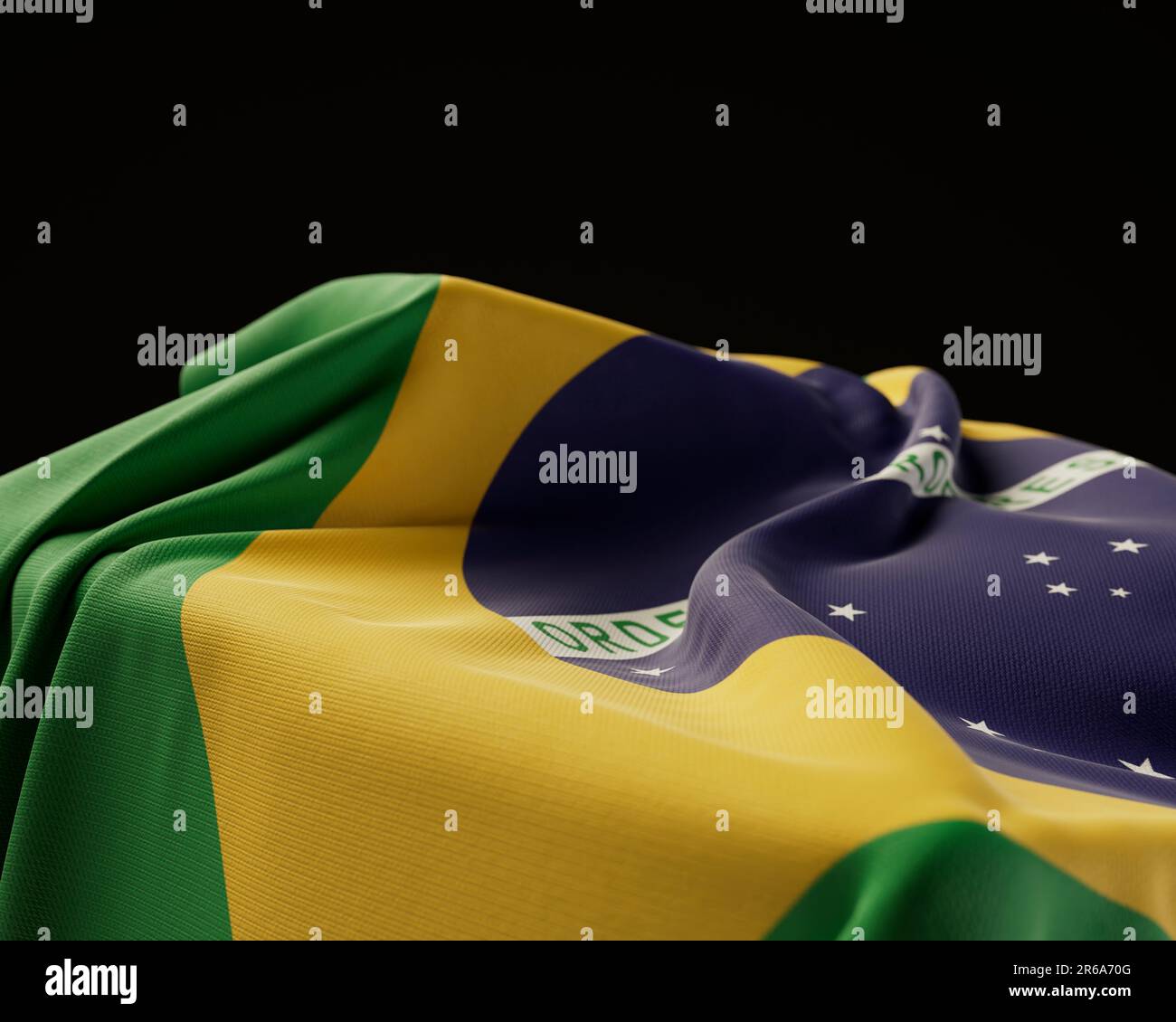 A brazil flag draped over a stone plinth on an isolated dark studio ...