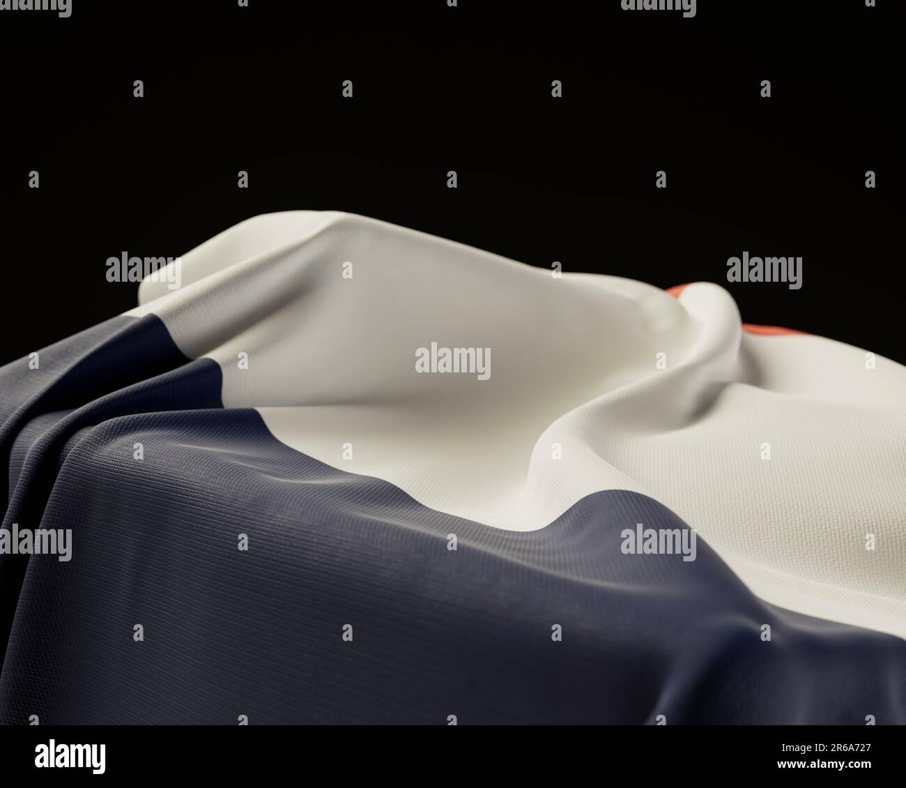 A france flag draped over a stone plinth on an isolated dark studio ...