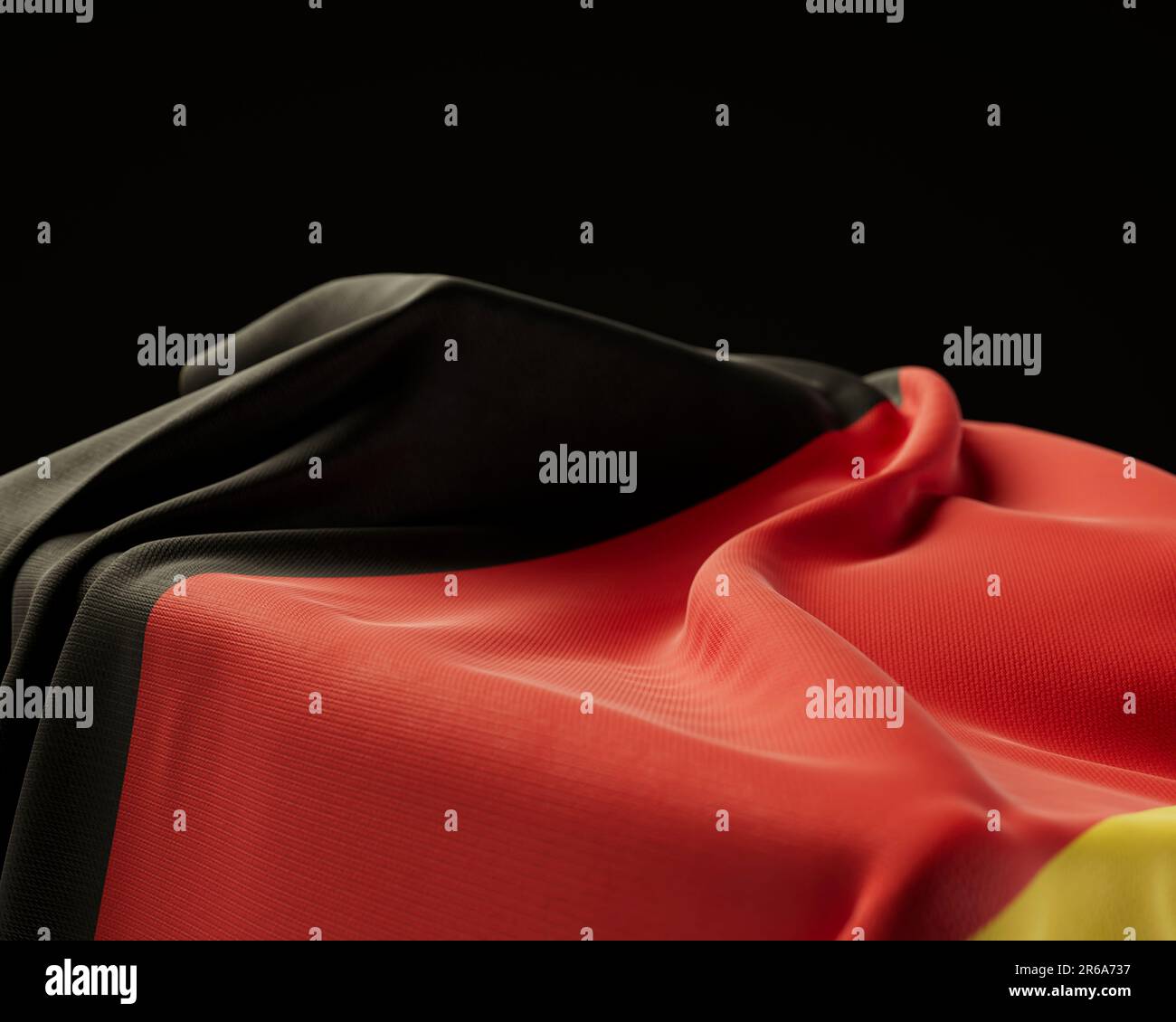 A germany flag draped over a stone plinth on an isolated dark studio ...