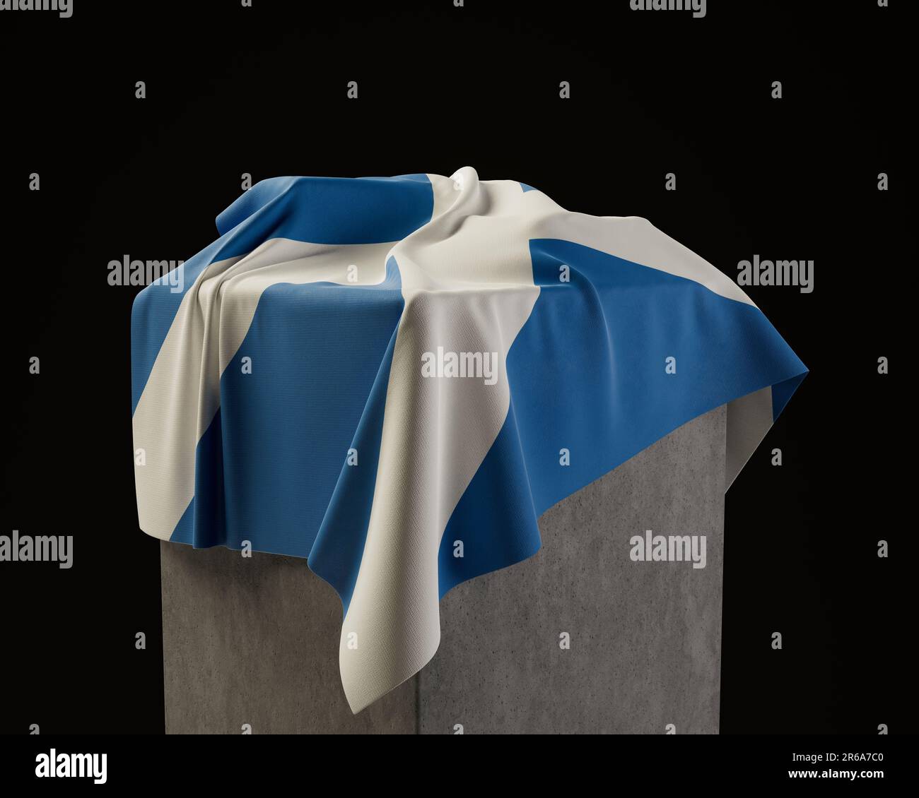 A scotland flag draped over a stone plinth on an isolated dark studio ...