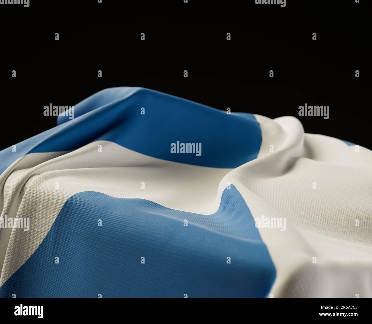 A scotland flag draped over a stone plinth on an isolated dark studio ...