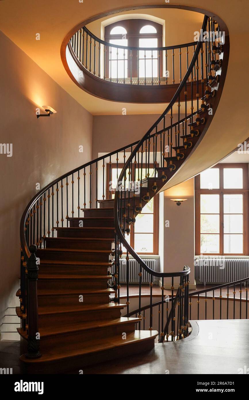 Winding spiral staircase with ornate wooden railings Stock Photo - Alamy