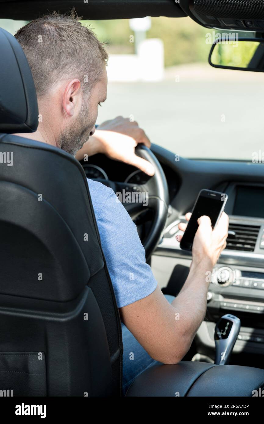angry man driving car and texting message on smartphone Stock Photo - Alamy