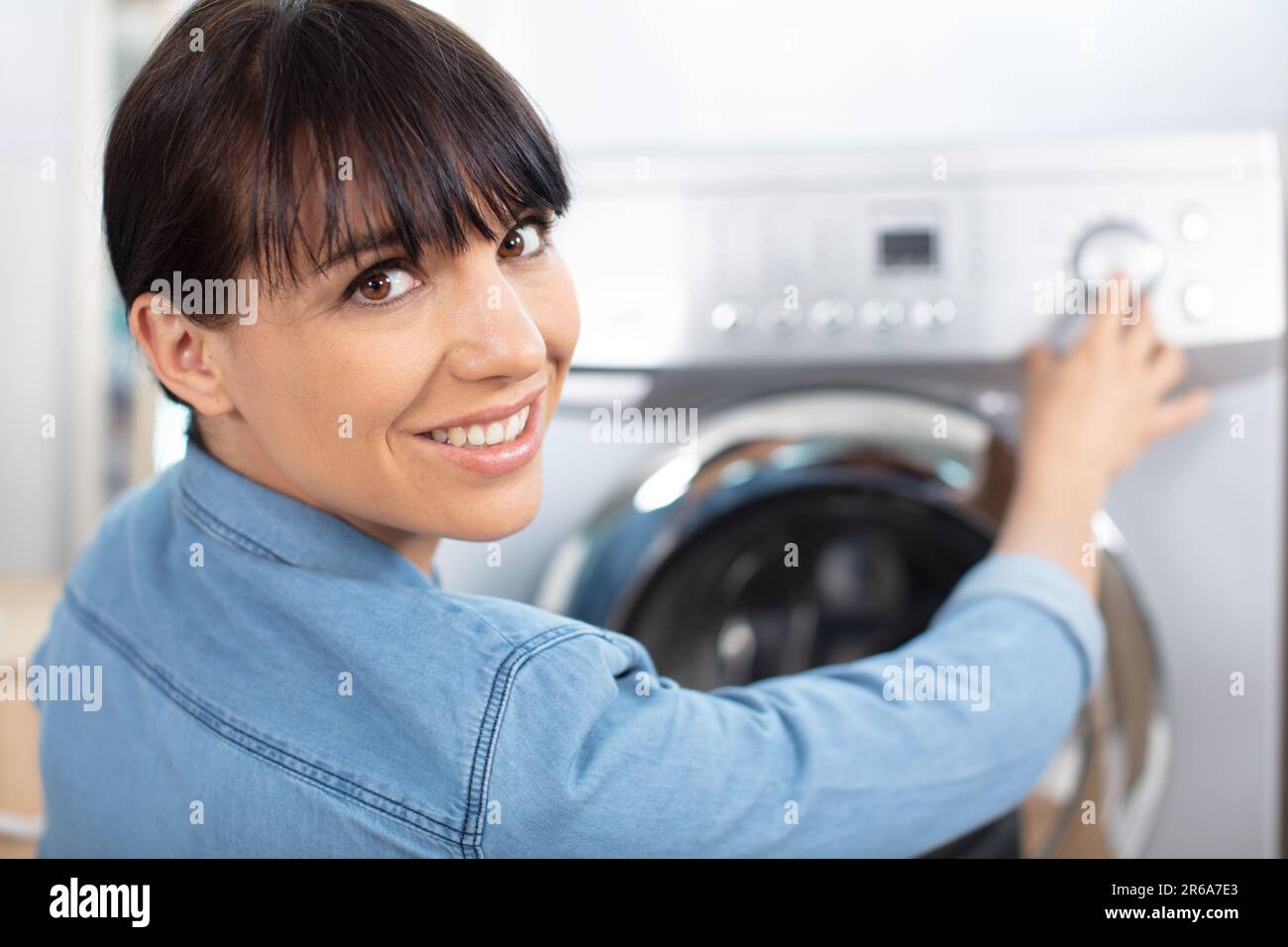 Woman turning on machine hi-res stock photography and images - Alamy