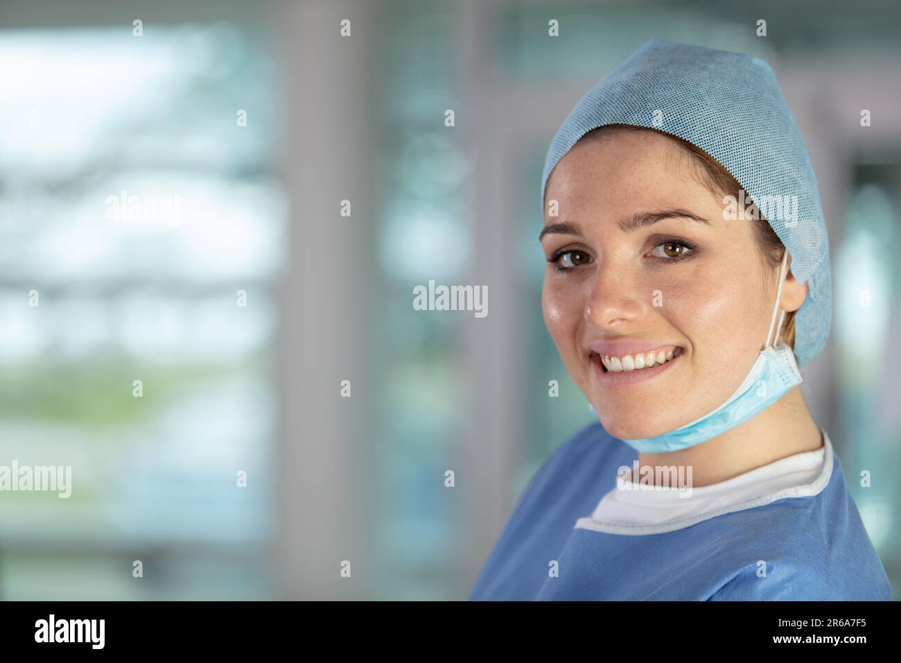 happy female nurse smiling behind surgeon mask Stock Photo - Alamy