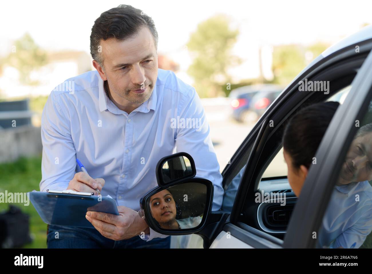 learner driver student driving car with instructor Stock Photo - Alamy