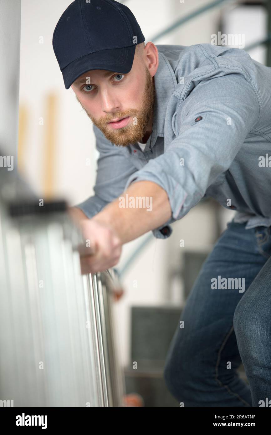 man moving carefully a ladder Stock Photo - Alamy