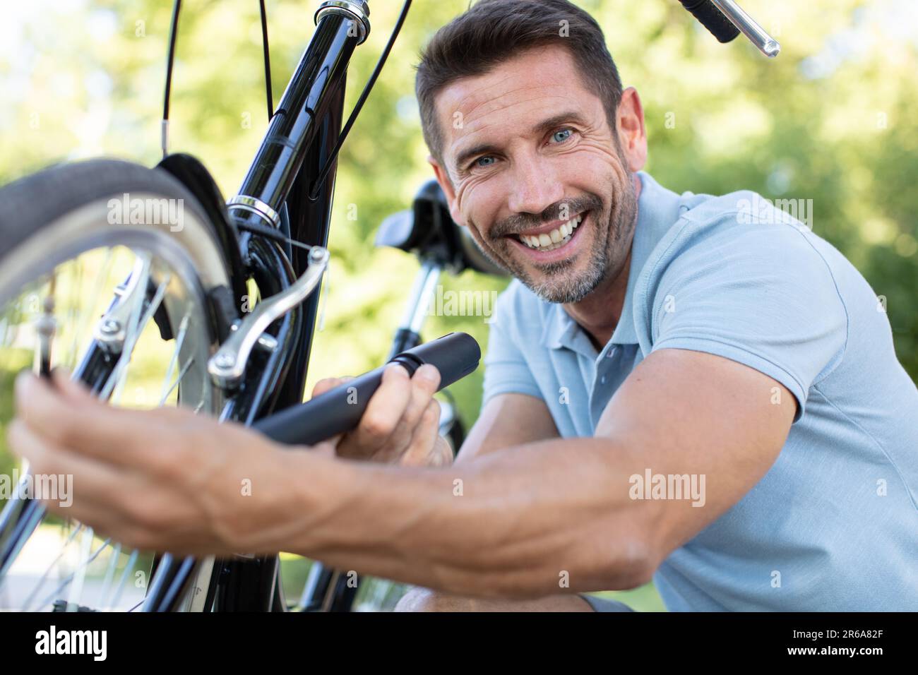 close up man inflating the wheel of a bicycle Stock Photo - Alamy