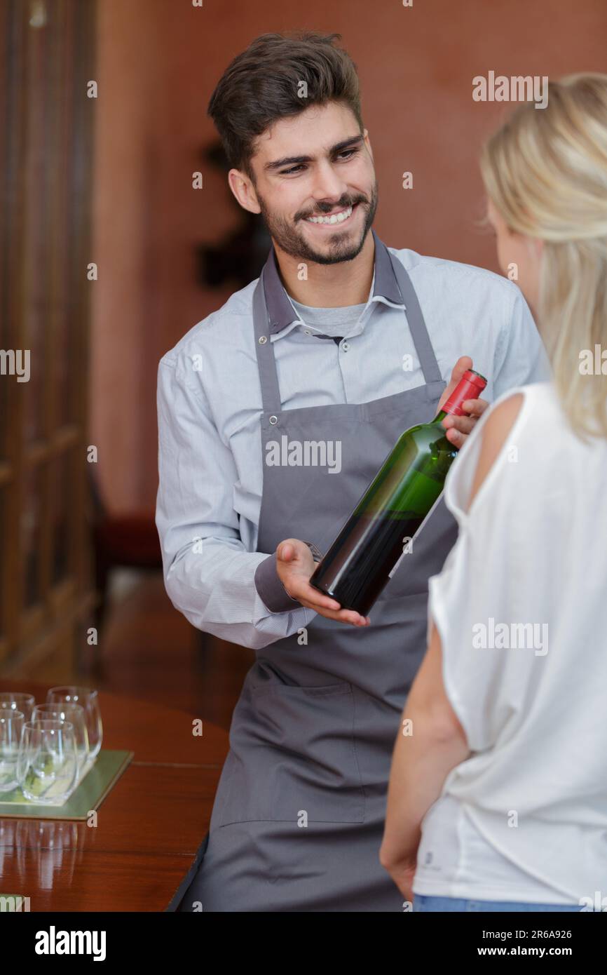 salesman assisting helping female customer Stock Photo - Alamy