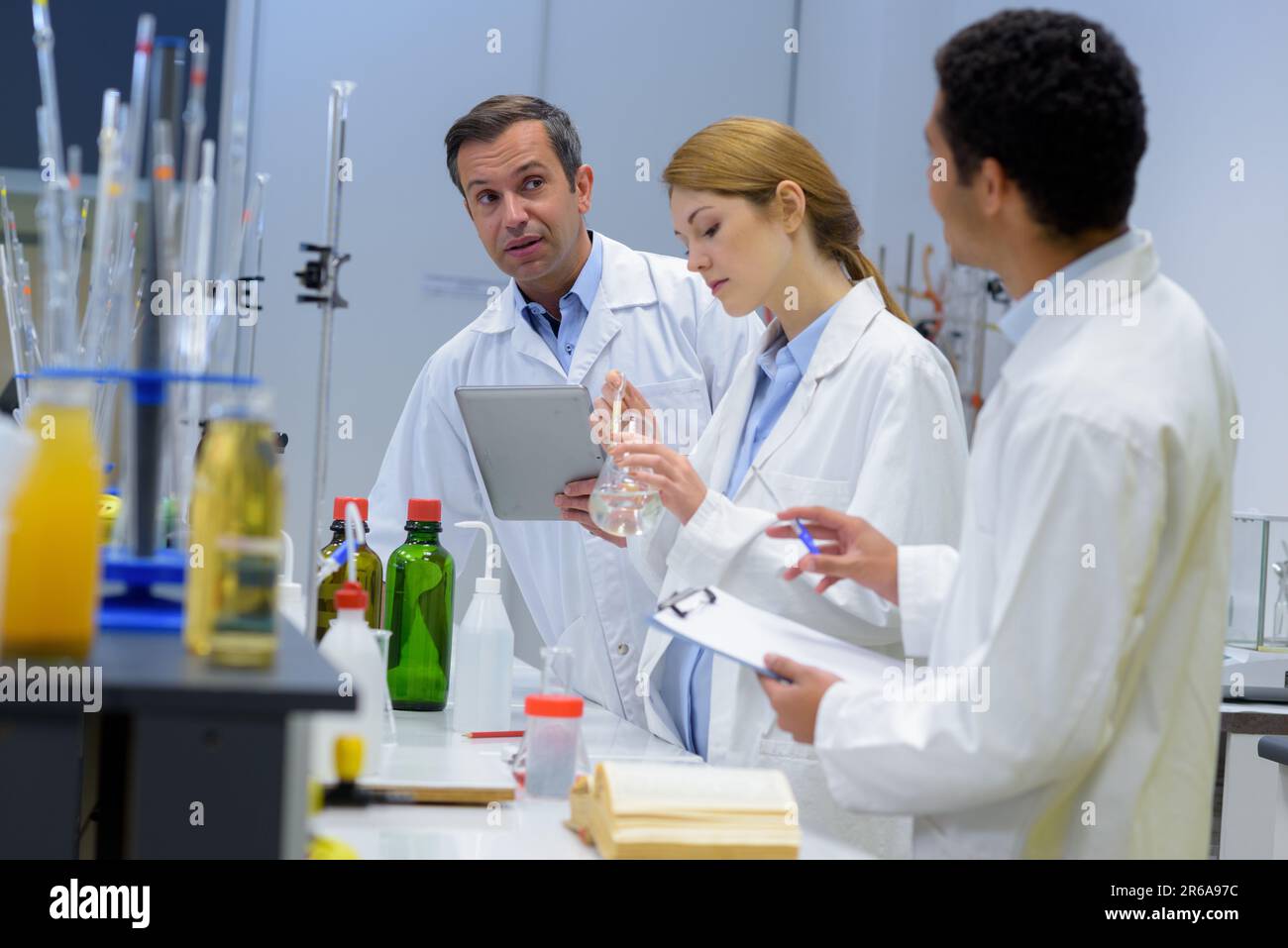 group of researchers during work on devices in laboratory Stock Photo ...