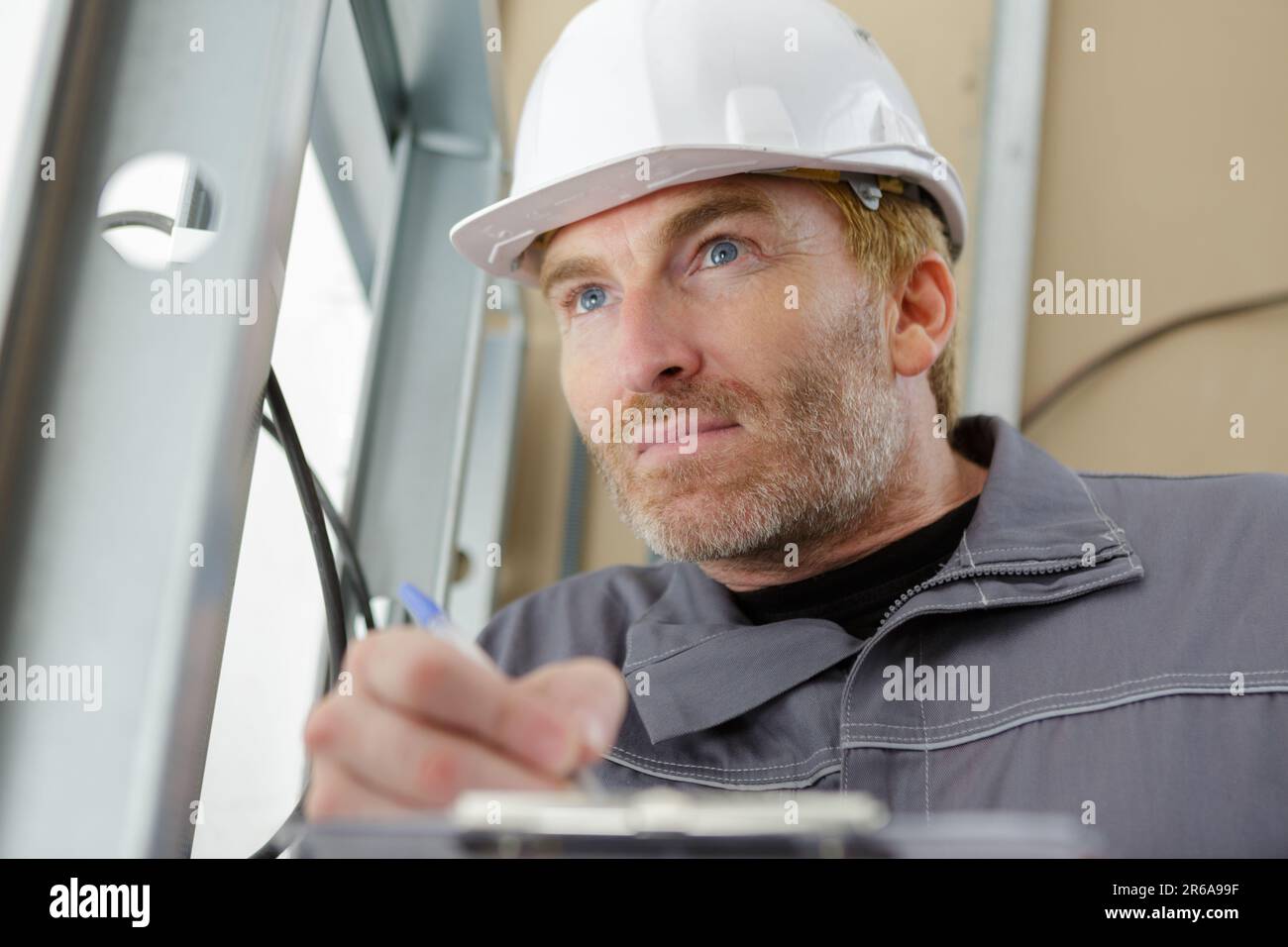 senior electrician concentrating on wiring Stock Photo - Alamy