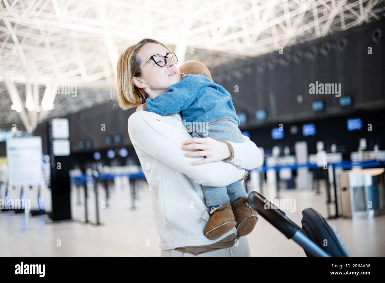 Motherat happily holding and lifting his infant baby boy child in the ...