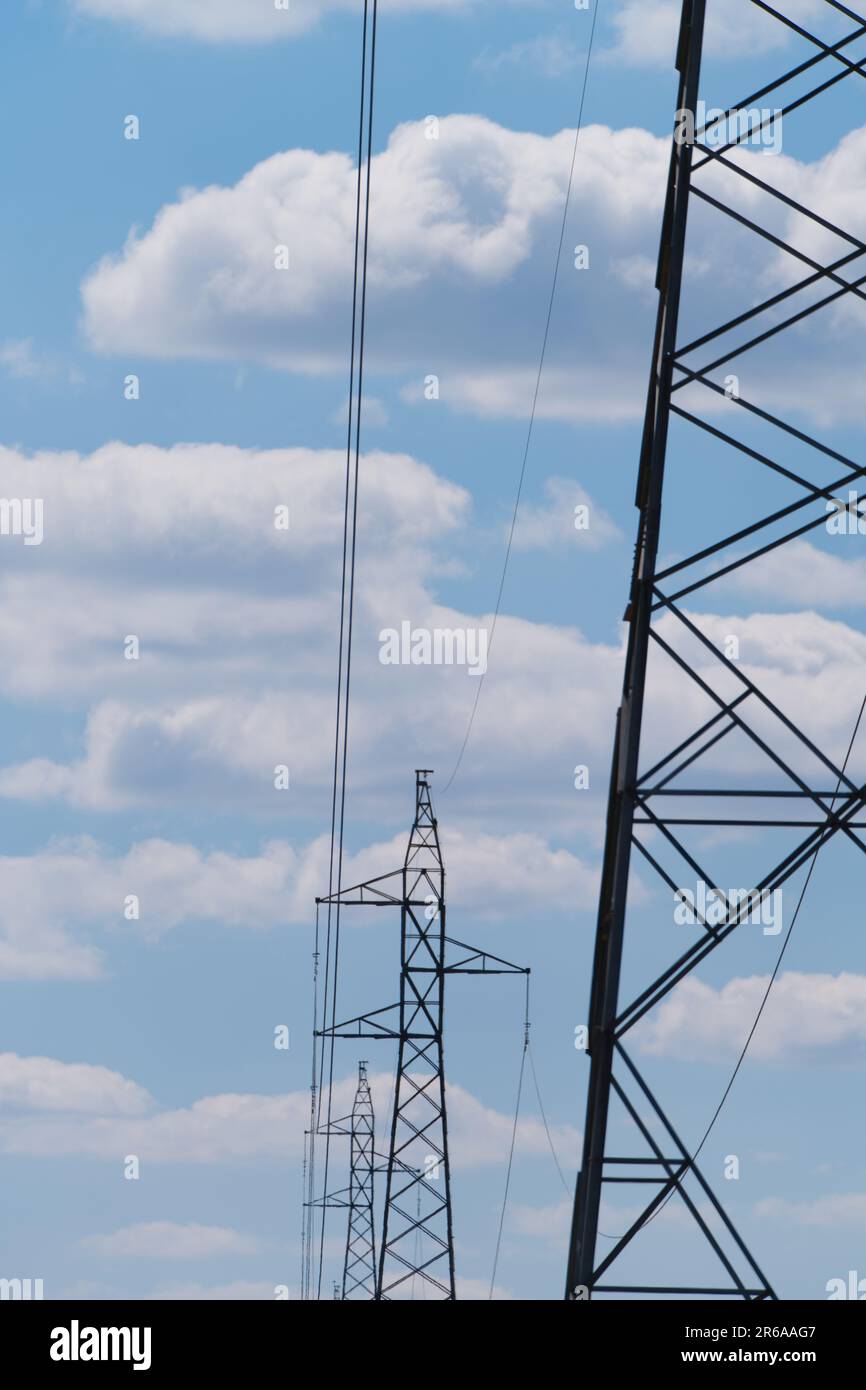 High voltage electricity pylons in a landscape background with cloudy ...