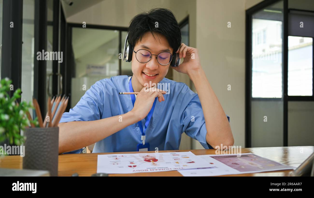 Medical student reading books, preparing for university exams in ...