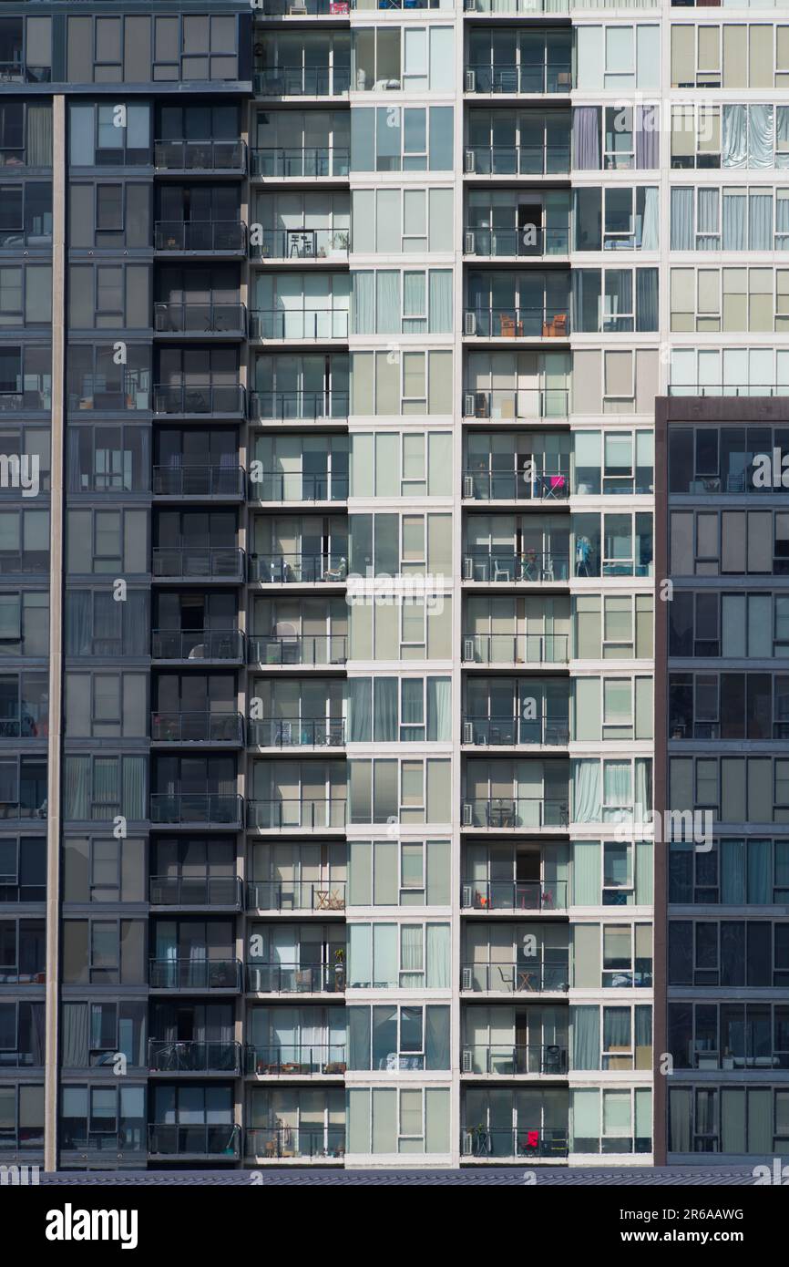 Modern city building apartment block with small balconies, glass ...