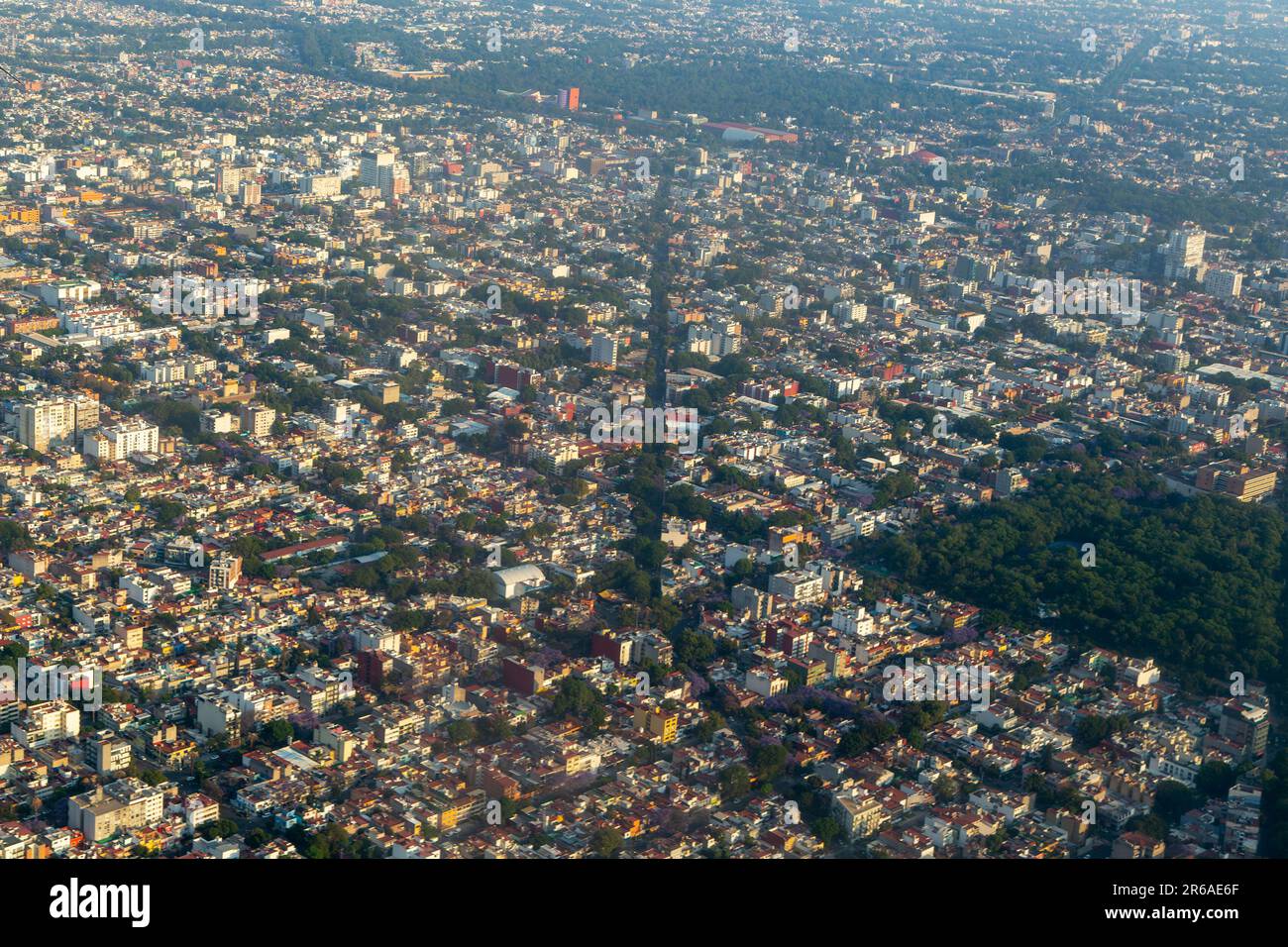 Oblique angle aerial view through plane window over Mexico City, Mexico ...