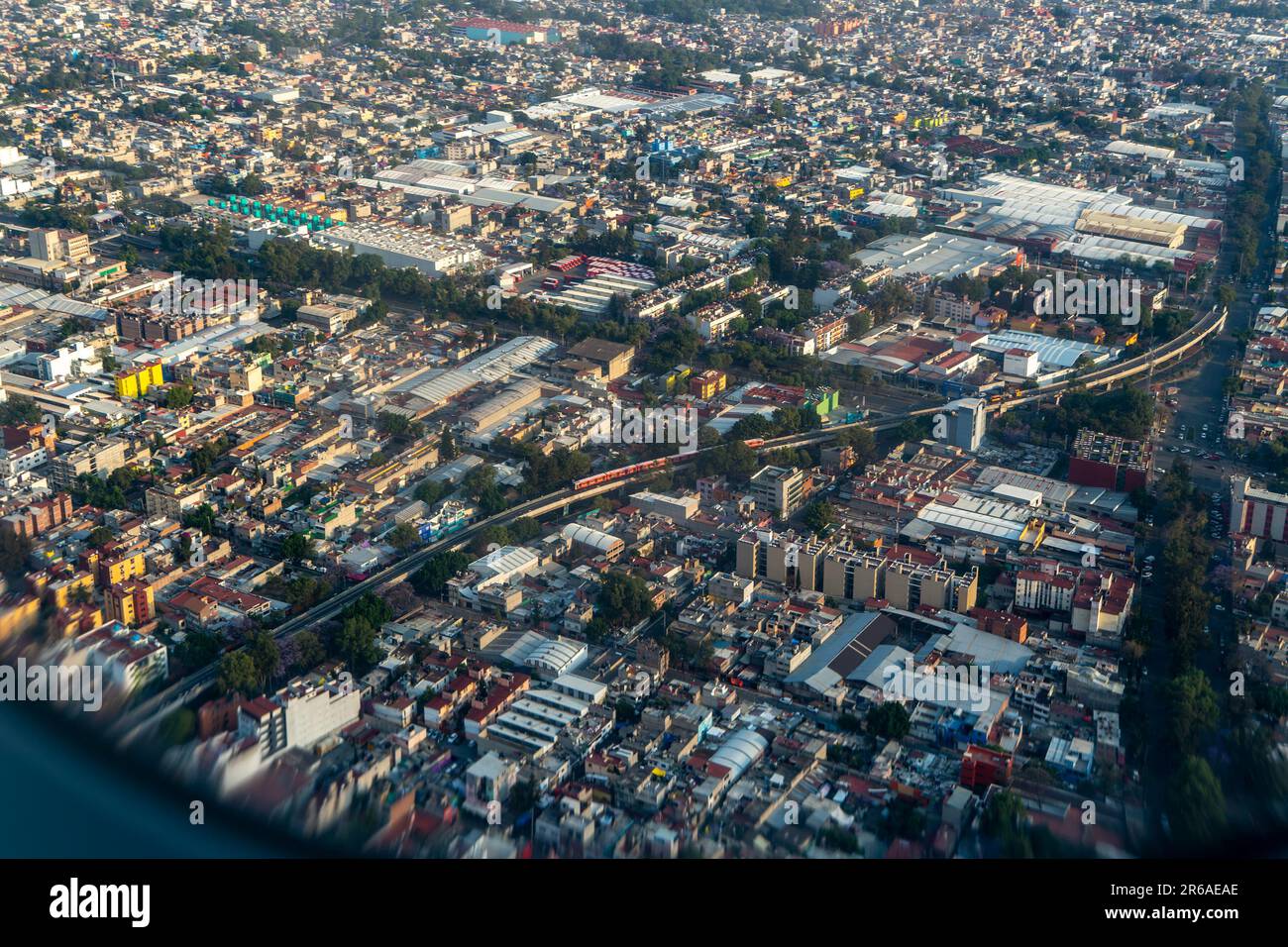 Oblique angle aerial view through plane window over Mexico City, Mexico ...