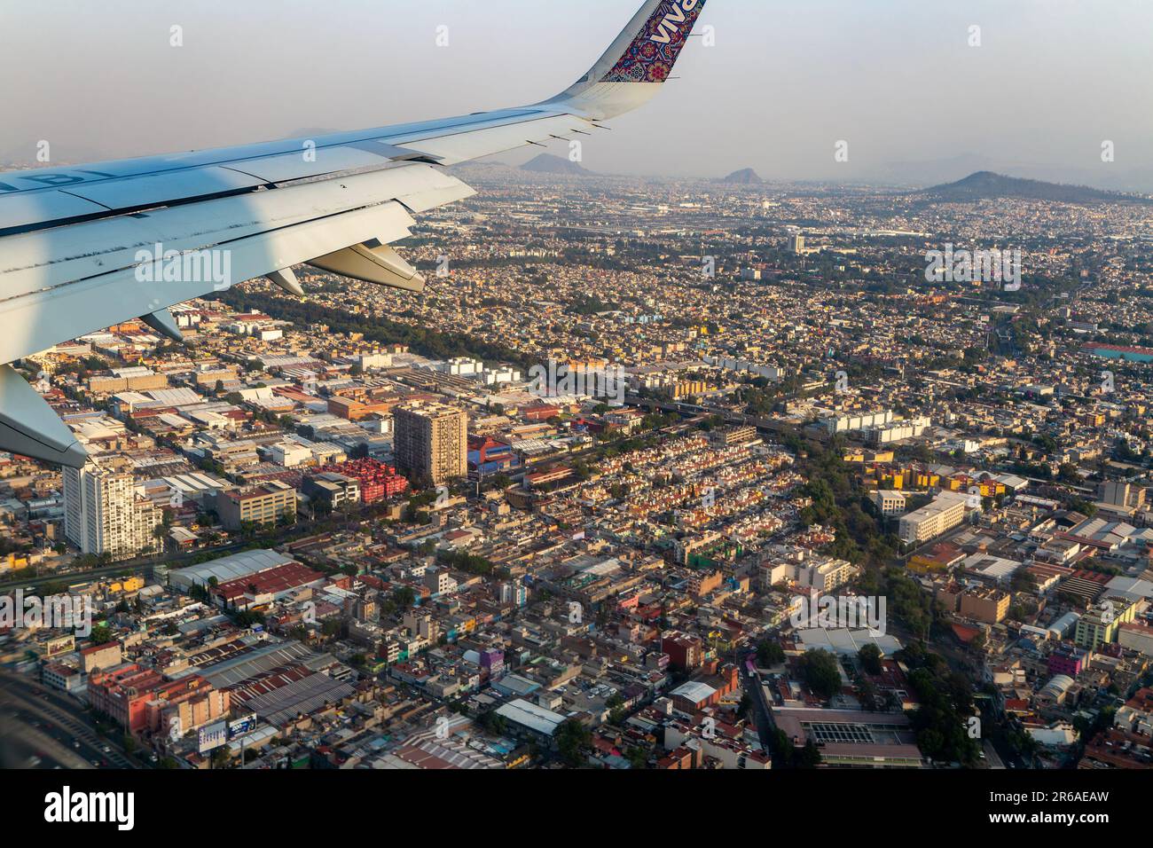 Oblique angle aerial view through plane window over Mexico City, Mexico ...