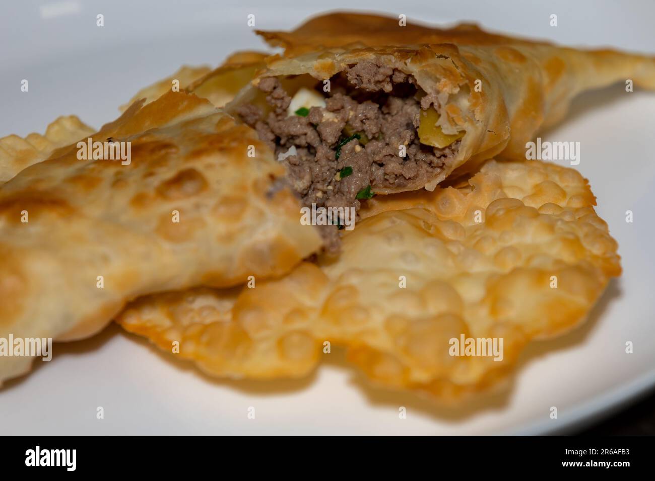 Traditional homemade rustic Brazilian pastry stuffed with ground meat ...