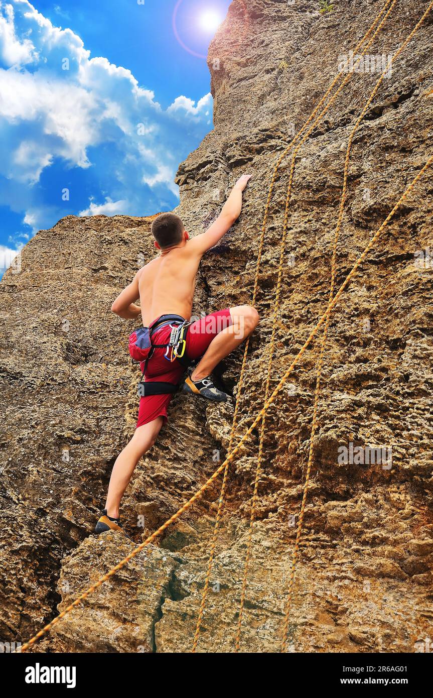 Alone man climbing rope hi-res stock photography and images - Alamy