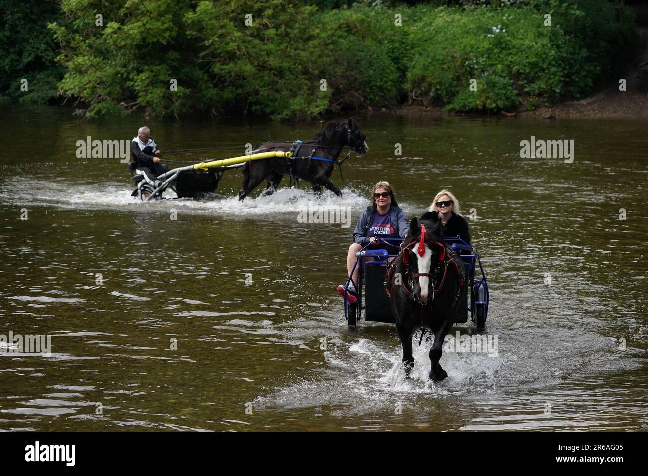 People ride their horses through the river during the Appleby Horse ...