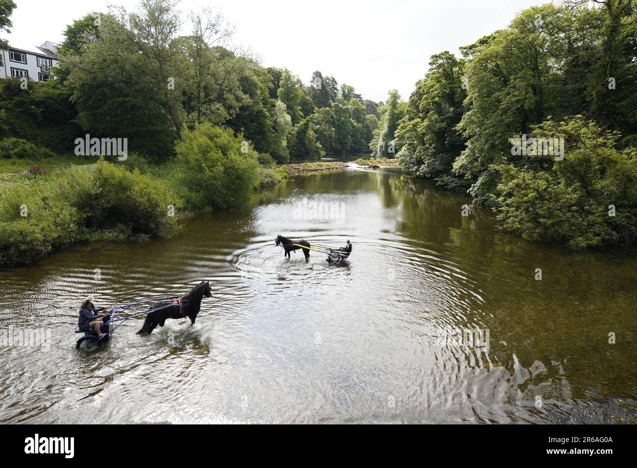 People ride their horses through the river during the Appleby Horse ...