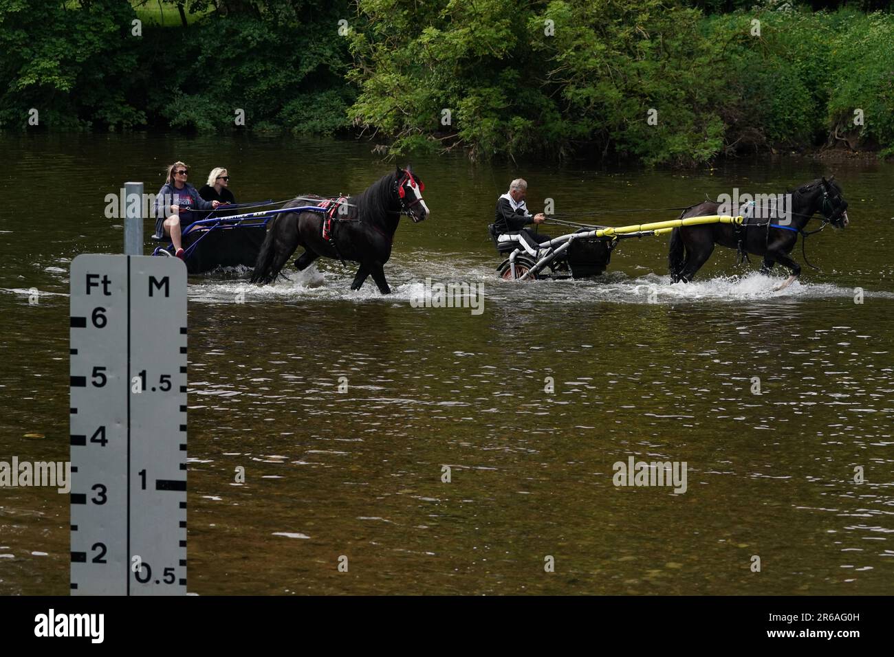 People ride their horses through the river during the Appleby Horse ...