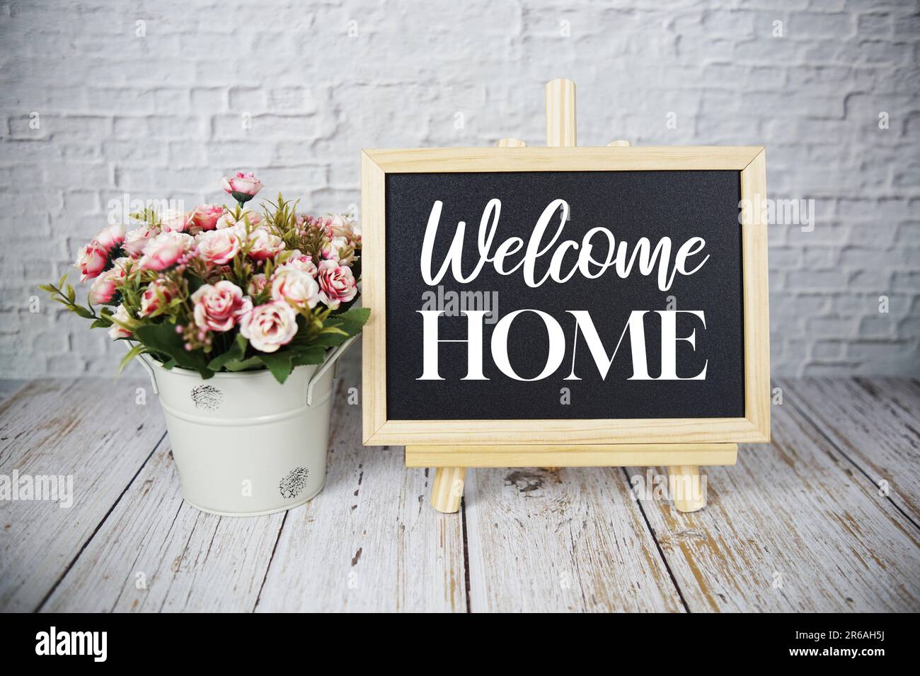 Welcome Home text message and flower decoration on wooden background ...
