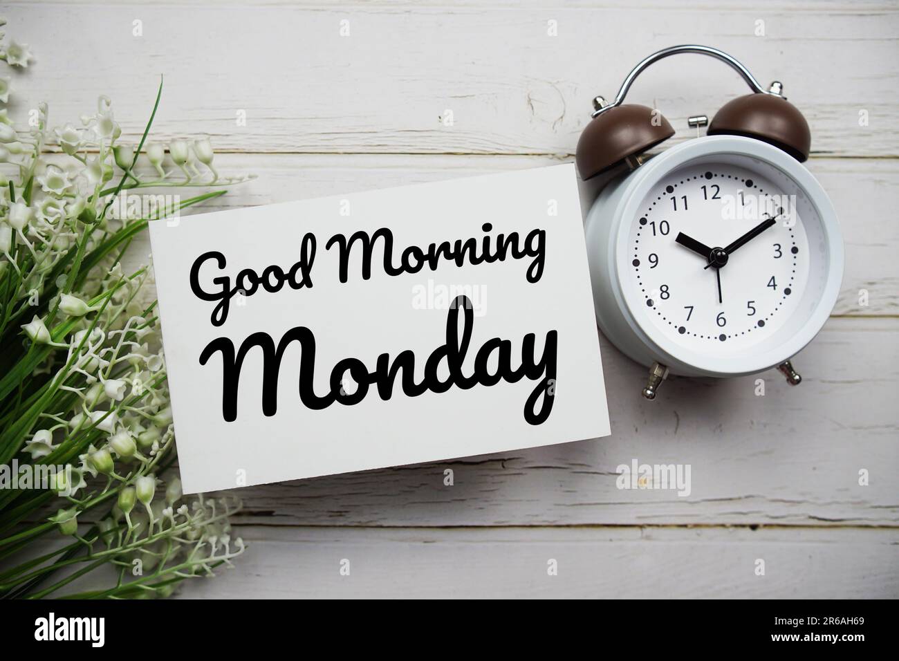 Good Morning Monday text message with flower and alarm clock on wooden ...