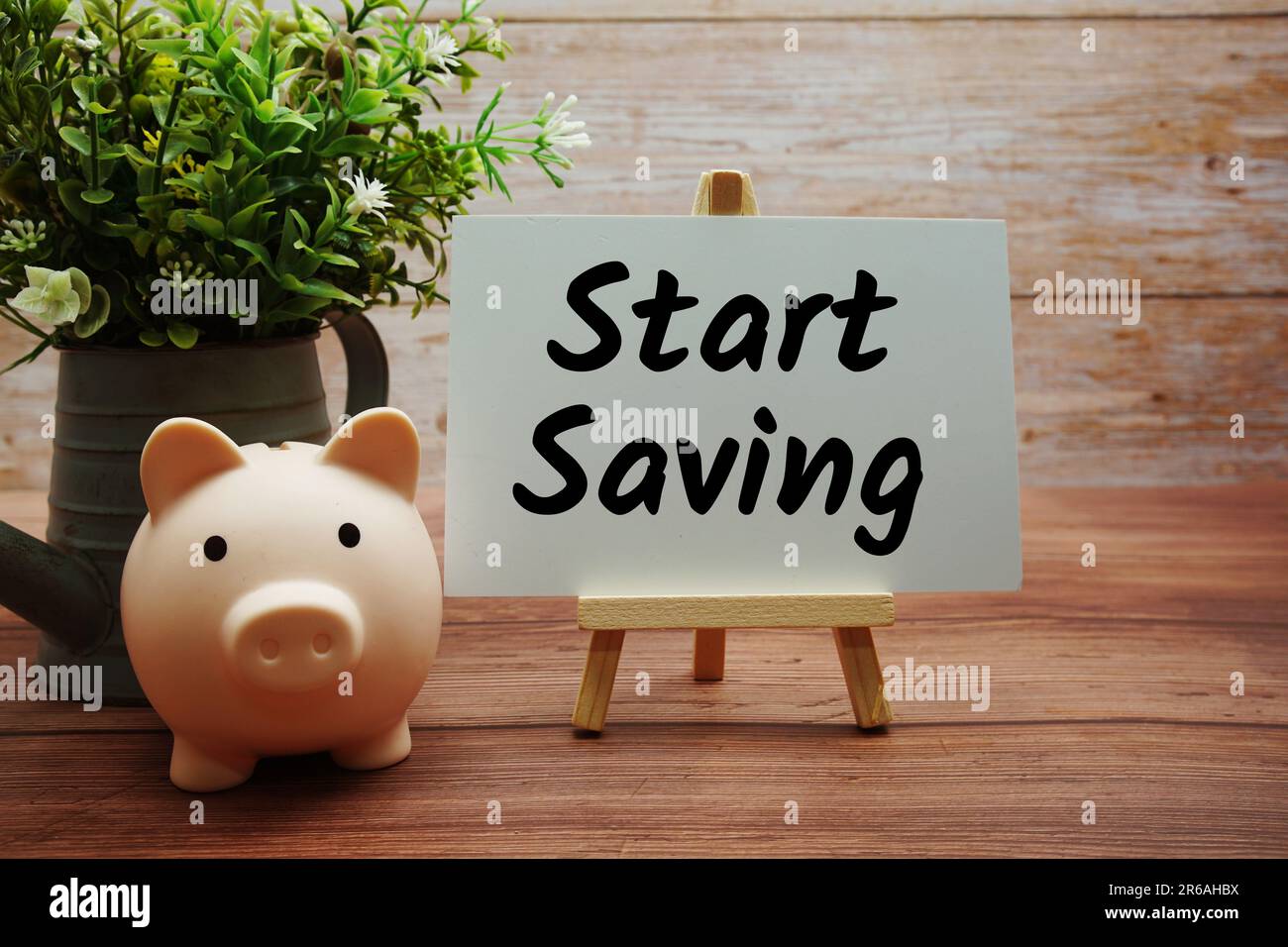 Start Saving text message with piggy saving on wooden background Stock ...