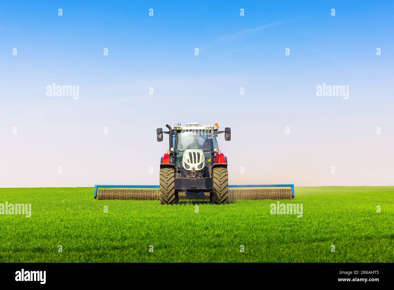Tractor with a roller tillage on spring field. Soil rolling supports ...