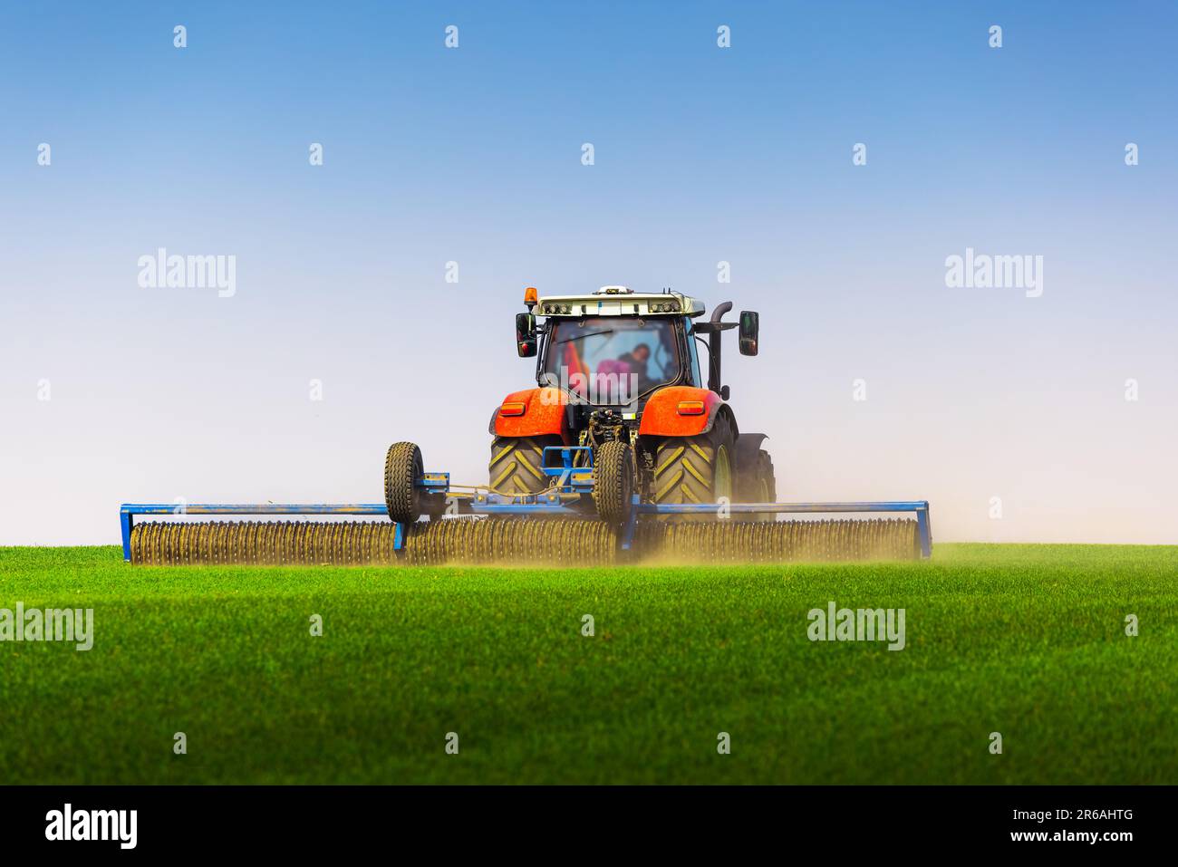 Tractor with a roller tillage on spring field. Soil rolling supports ...