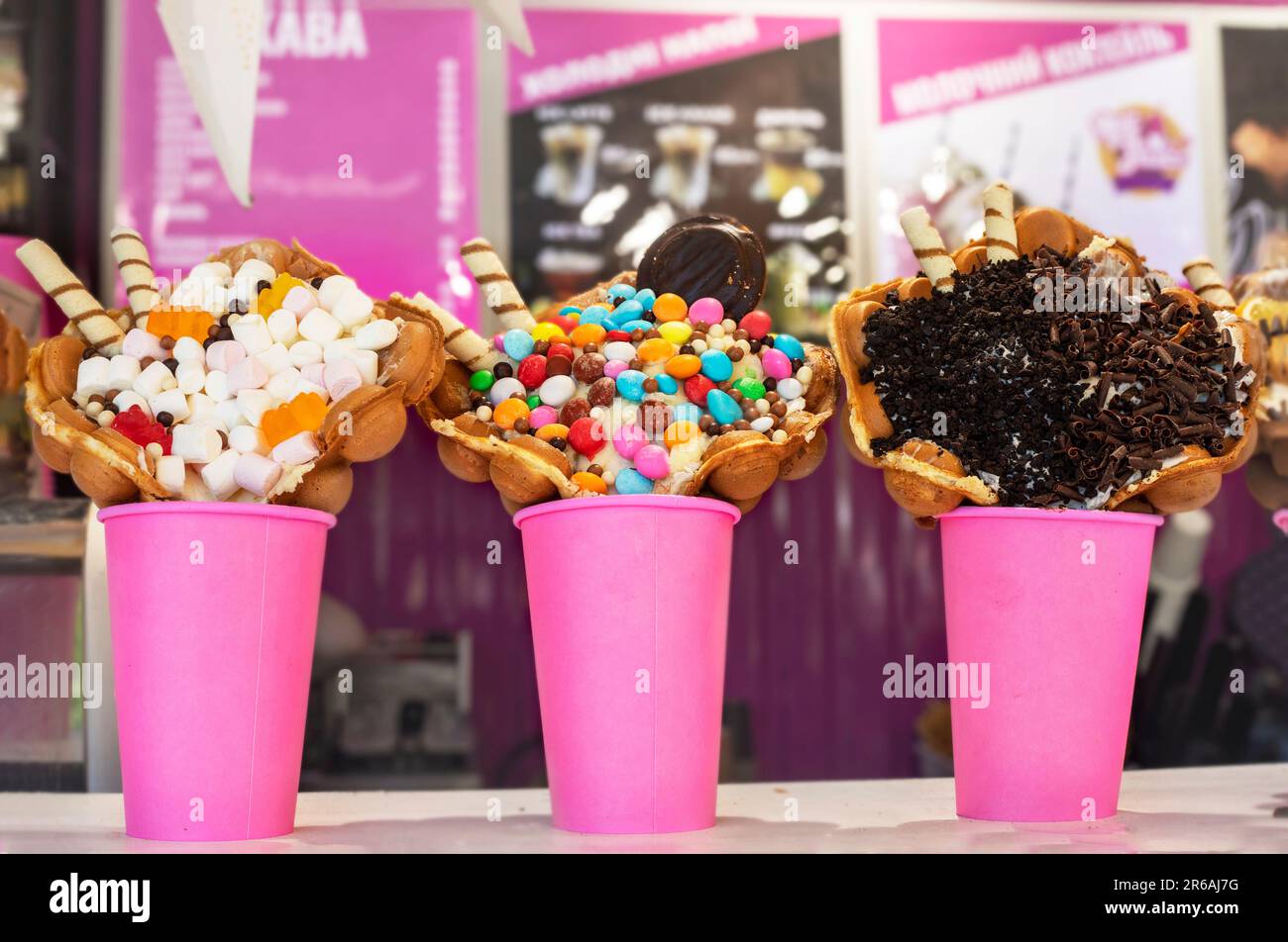 showcase with a crown of different varieties of ice cream in waffle ...