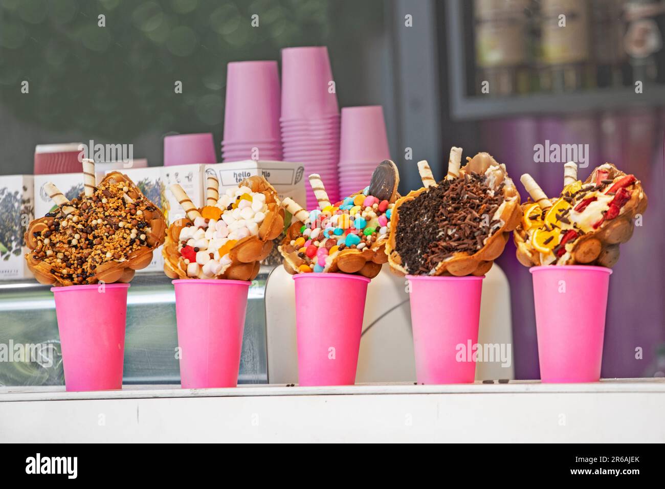 different varieties of ice cream in waffle cones with marmesh, nuts ...