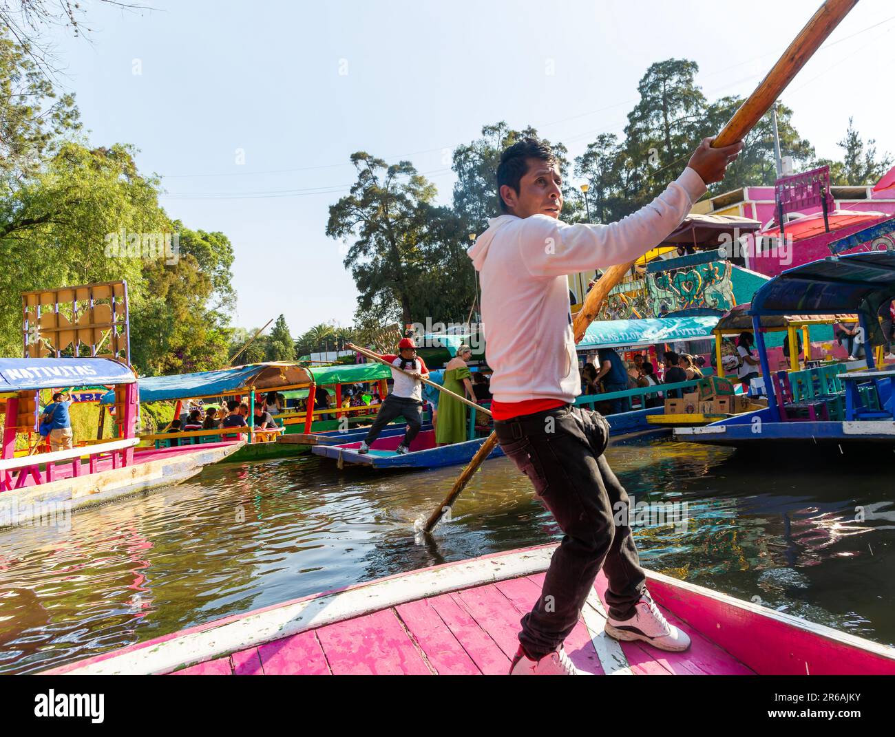Popular tourist attraction people boating on colourful barges on canal ...