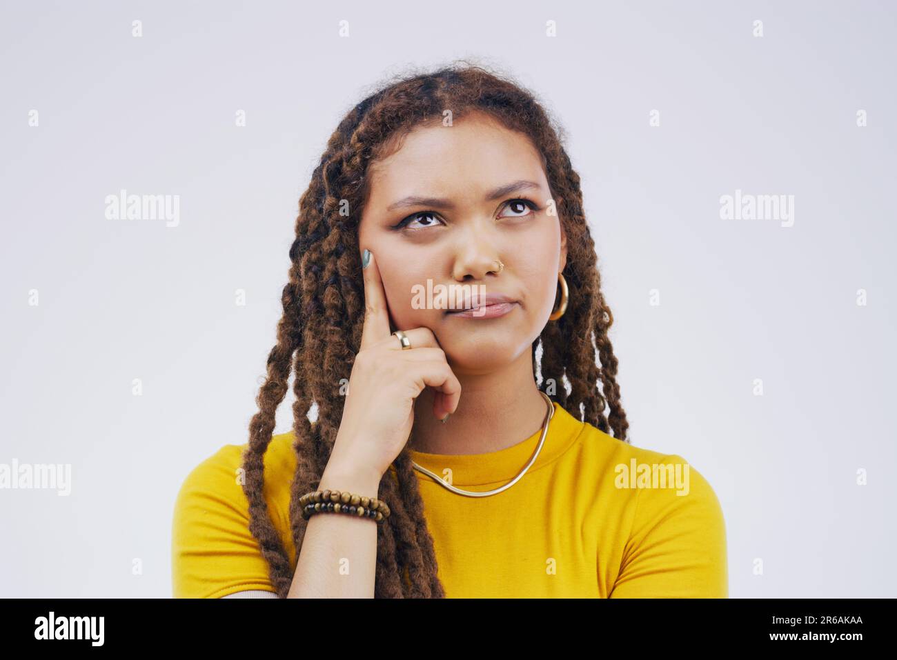 Doubt, confused and gen z girl thinking in studio on mockup, space and ...