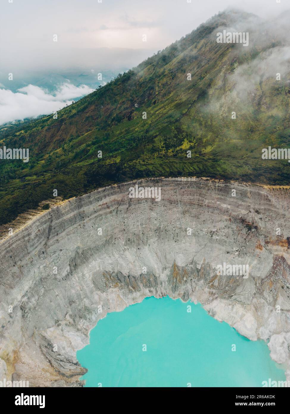 Top aerial view of turquoise sulfur water lake, surrounded by rock ...