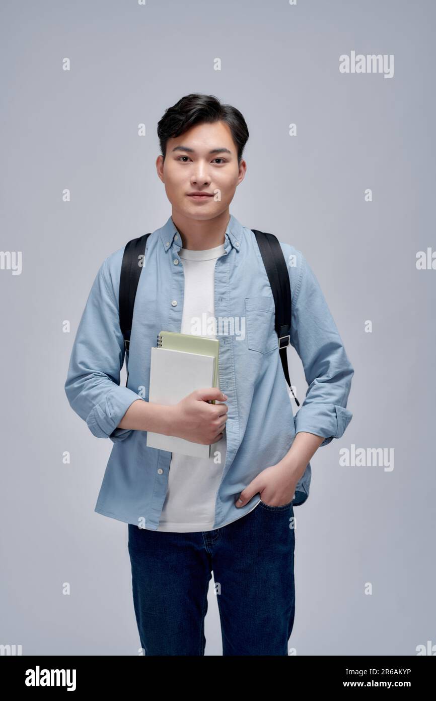 Smiling happy asian young man student holding backpack standing ...