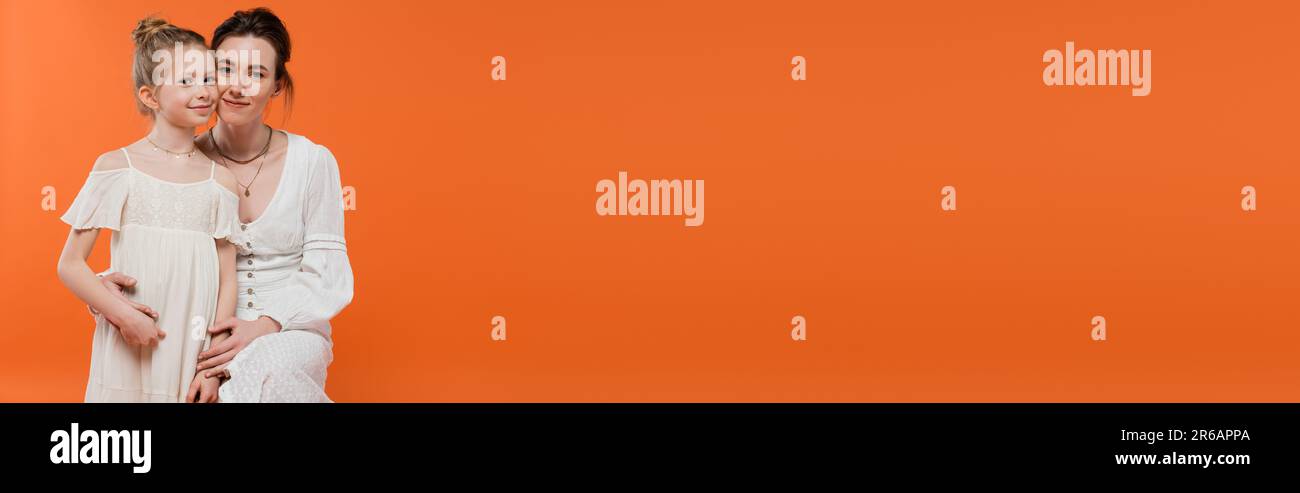 motherly love, happy young woman hugging preteen girl on orange ...