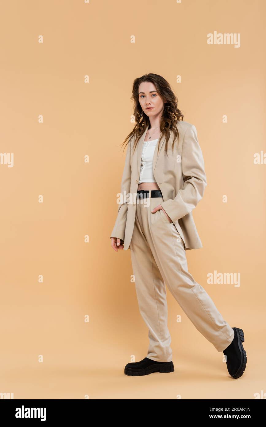 fashion trend concept, young woman with wavy hair walking in ...