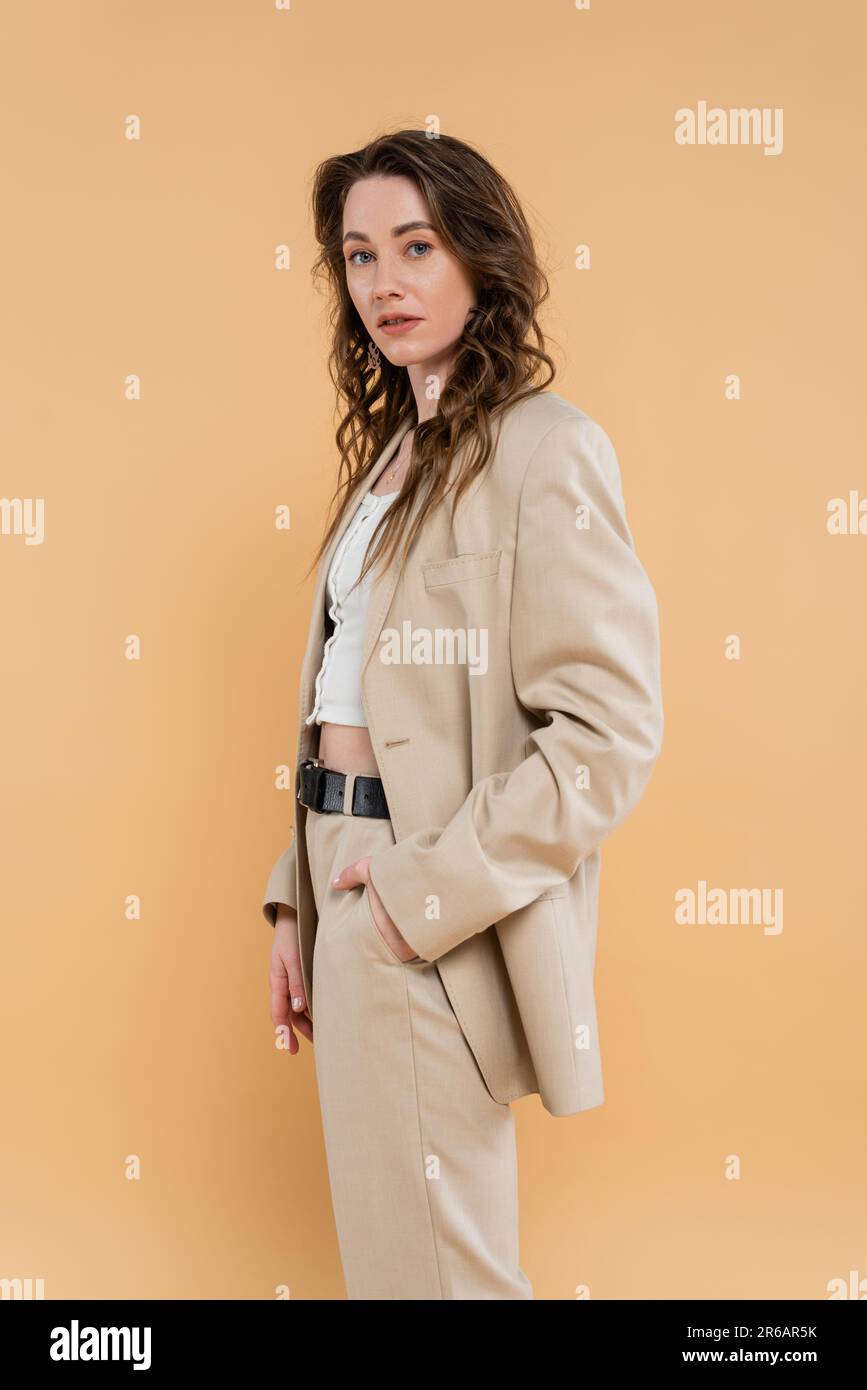 style and fashion concept, young woman with wavy hair standing in ...