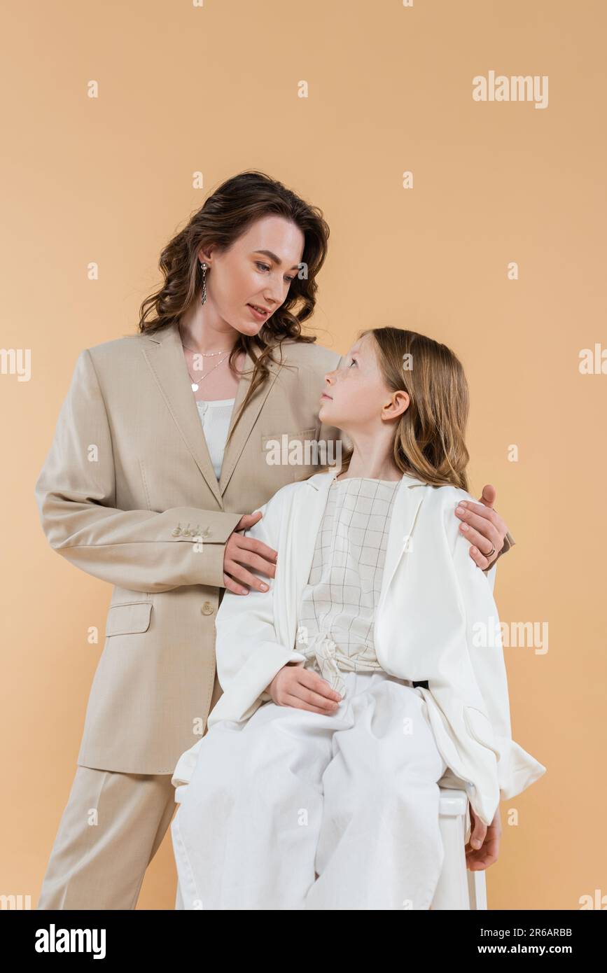 business mother and daughter in suits, woman hugging shoulders of girl ...
