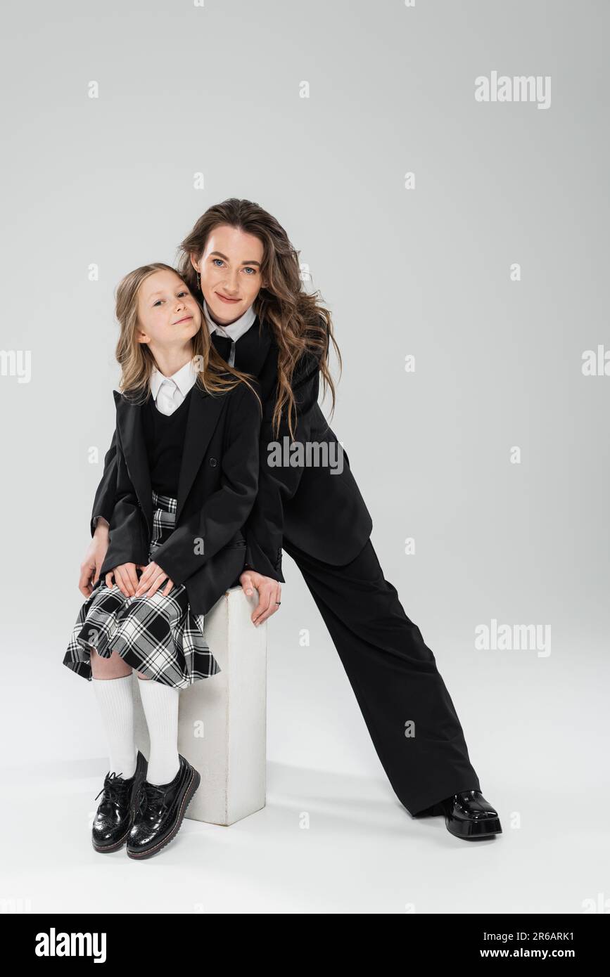 mother and child, happy businesswoman in formal attire standing near ...