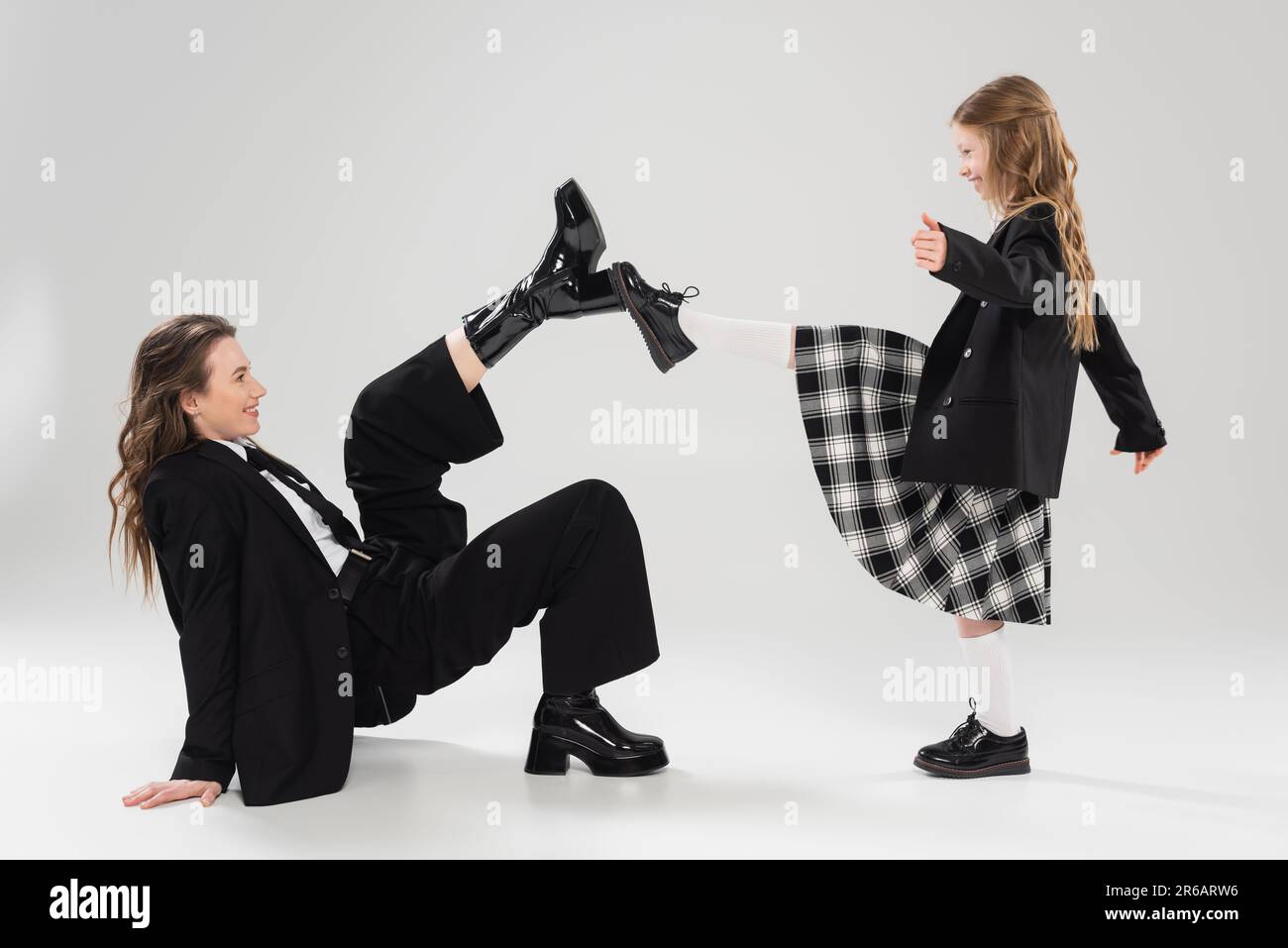 modern parenting, having fun, side view of happy mother in suit and ...