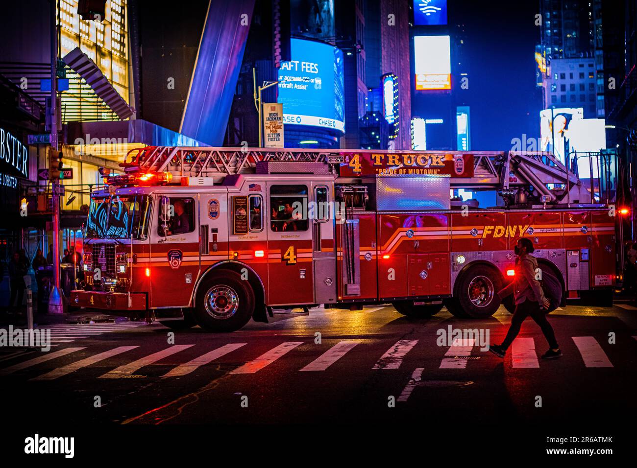 A nighttime scene of a metropolitan street, illuminated by the lights ...