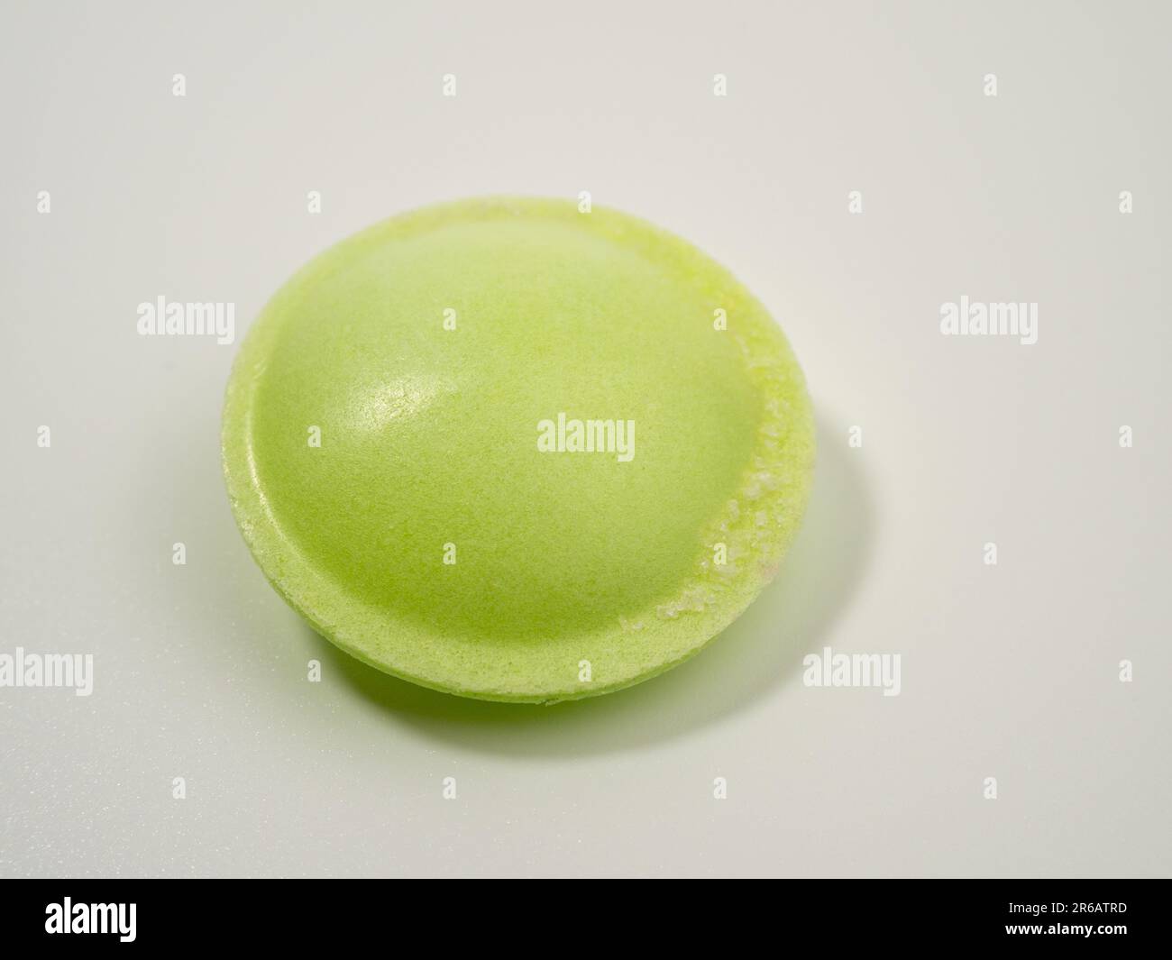 Sweet candies in the shape of a UFO in different colors on a white ...