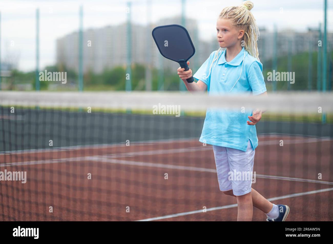 Portrait little teenage girl playing pickleball game, pickleball yellow ...